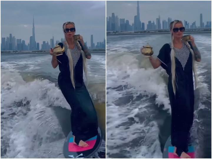 woman is seen drinking tea while surfing waves in Dubai | समुद्री लहरों ...