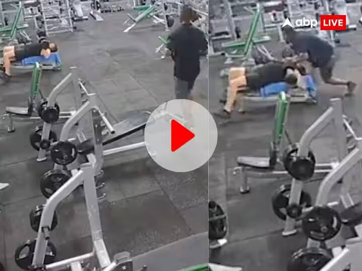 man drop 20 kg weight dumbbell on other man during exercise in gym ...