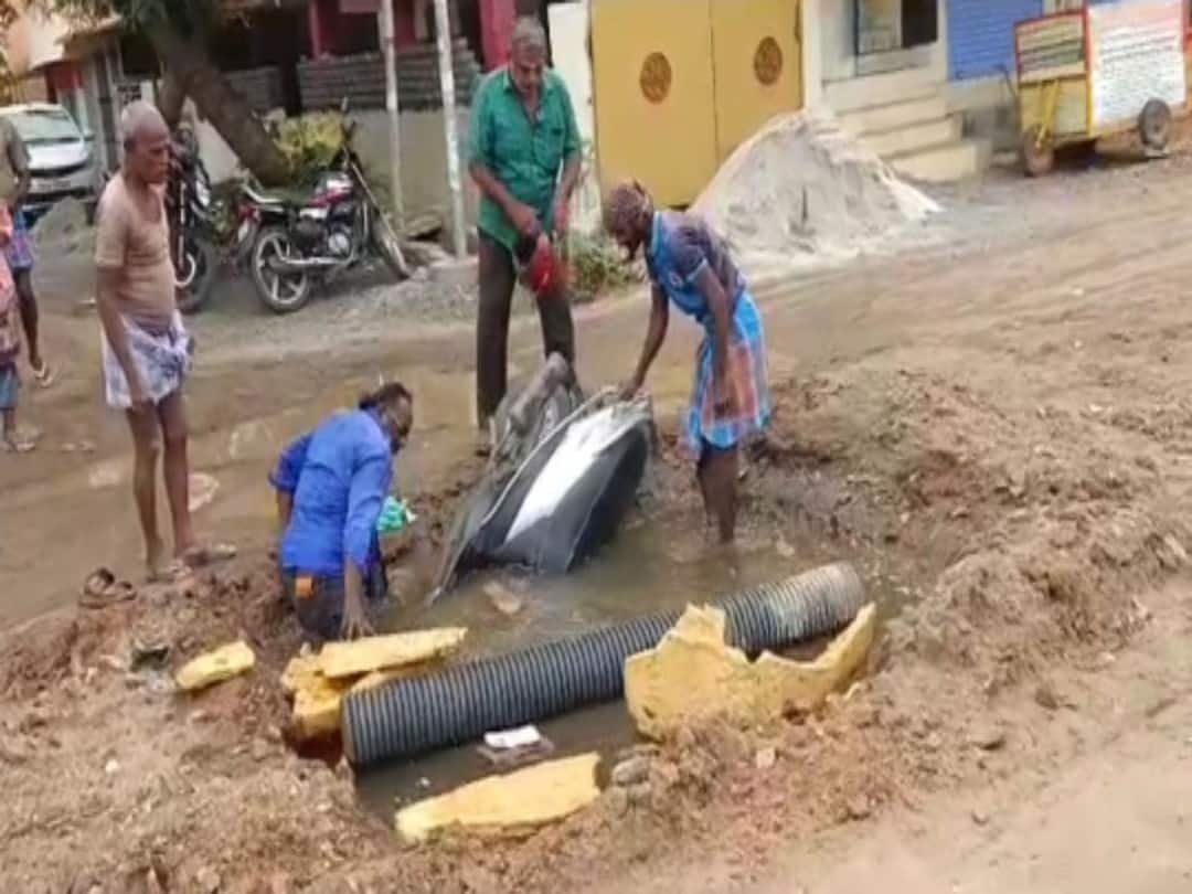 A video of a man falling with a two-wheeler into a pothole on the road ...